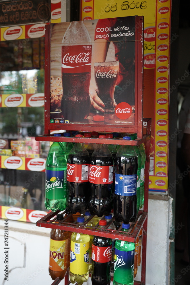 bottles on a shelf in a store. The bottles of soft drinks, Sprite, Coca ...