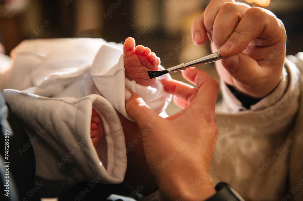 Baby leg. Priest and godfather stretch hands to legs. Temple, Orthodoxy ...