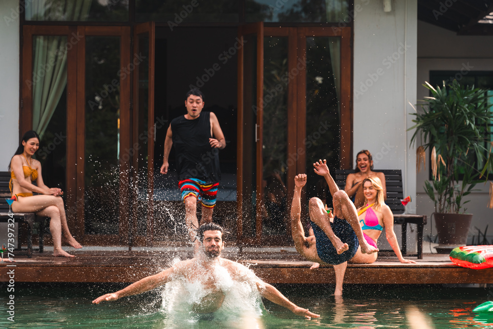 happy friend group having holiday party together at swimming pool water ...