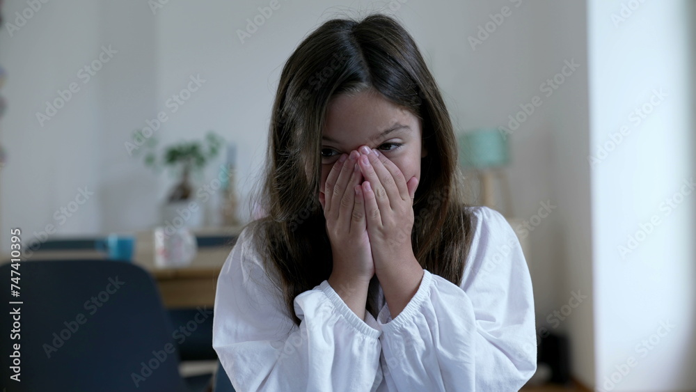 Little girl baffled reaction by covering mouth and face with hands ...