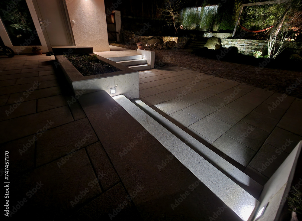 lighting of stairs and steps on the concrete wall on the side of the ...
