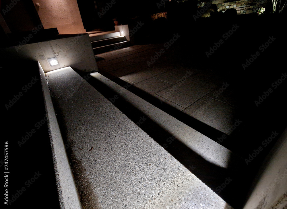 lighting of stairs and steps on the concrete wall on the side of the ...