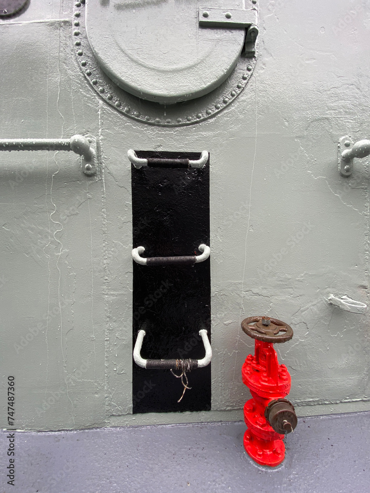 Red fire hydrant and ladders on a boat. Water pump and emergency exit ...