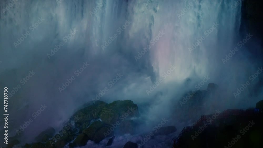 Rainbow lights bounce off the majestic flow of the mighty Niagara Falls ...