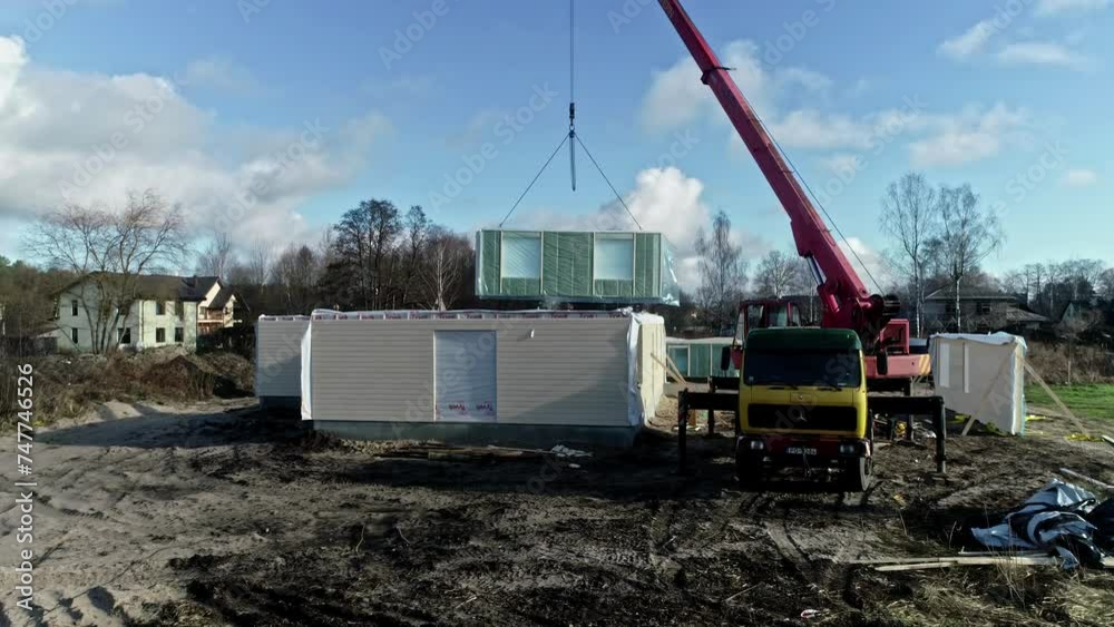 Assembly Of Modular Prefab House With Mobile Crane In Daytime. wide shot Stock Video | Adobe Stock