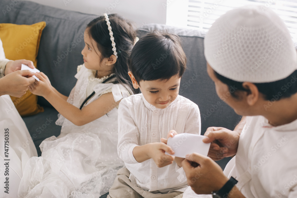 Muslim parents give money to their children during Eid Al Fitr ...
