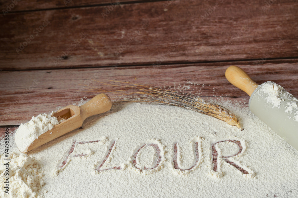 sifted flour on a wooden table with the word flour written on it, next ...