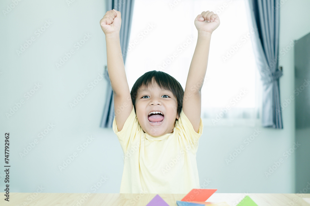 Asian 5 years old boy kid raise his both hands up with happiness as a ...