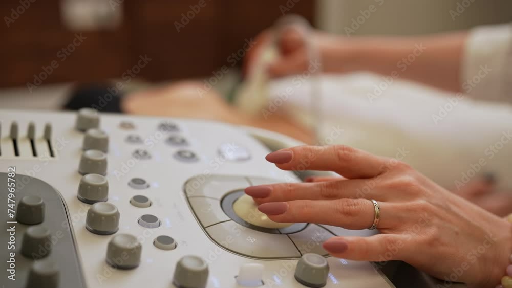 Closeup hands of female doctor using medical ultrasound machine for ...
