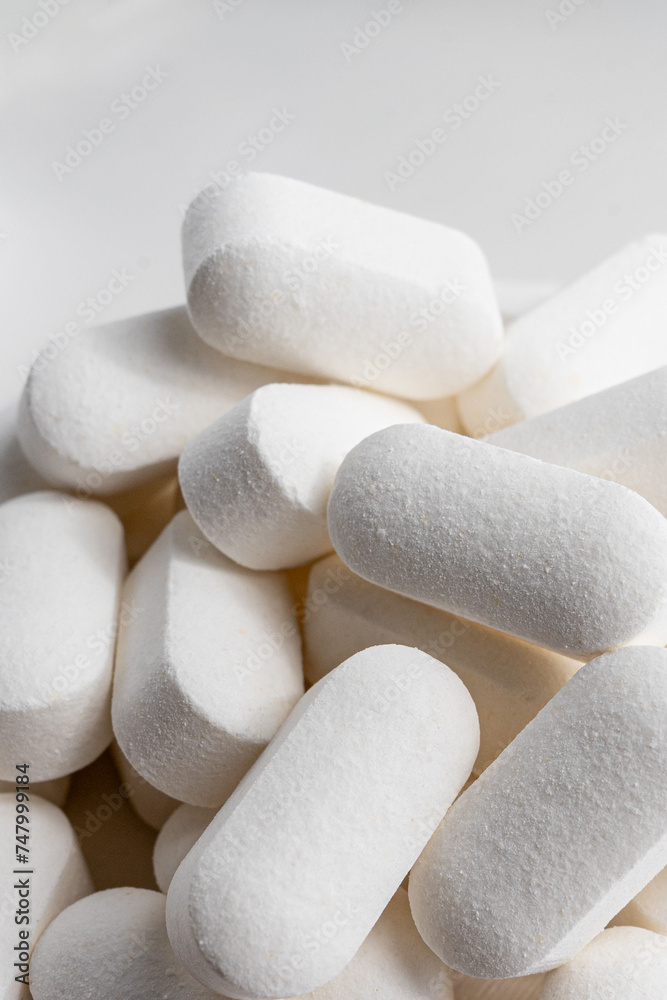 L-carnitine tablets stand out on a white background, conveying health ...