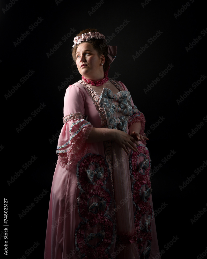 close upProfile portrait of female model wearing an opulent pink gown ...