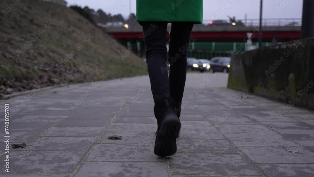 Stalker following his victim. Low angle view of woman legs walking ...