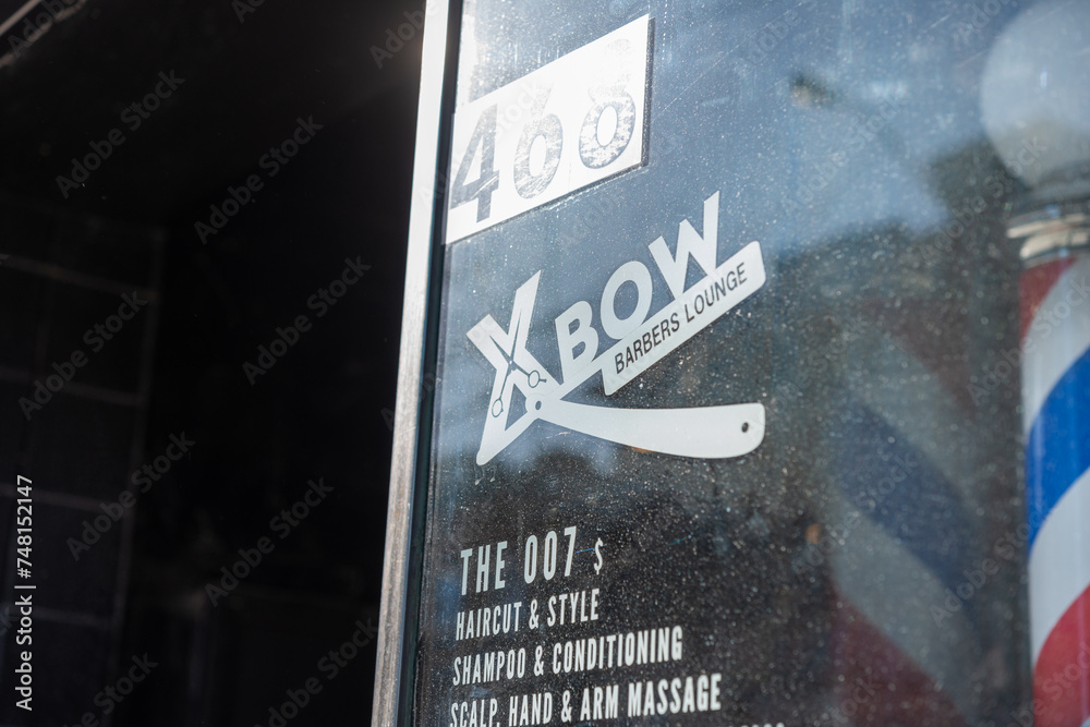 exterior display window with decal signs for Xbow Barbers Lounge, a ...