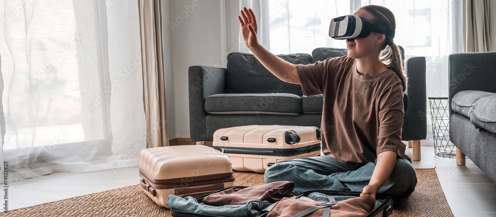 Travel,woman packing luggage in suitcase and travel in VR glasses ...