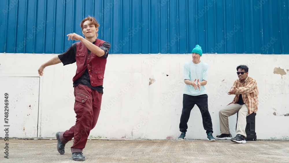 Young street dancer dancing in hip hop style with multicultural friends ...