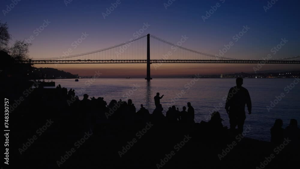 Silhouette of people watching and taking photos of sunset in Jardim do ...