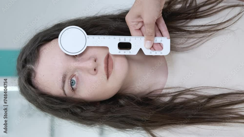 Attentive optometrist examining a beautiful female patient, testing her ...