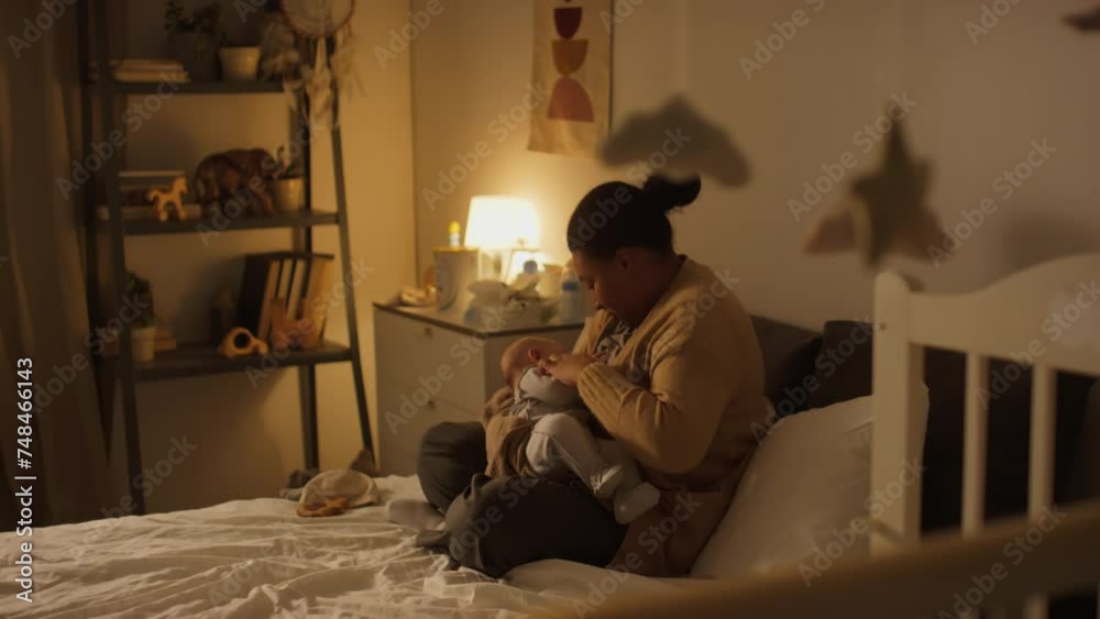 Full side shot of young polyethnic mother sitting with crossed legs on ...