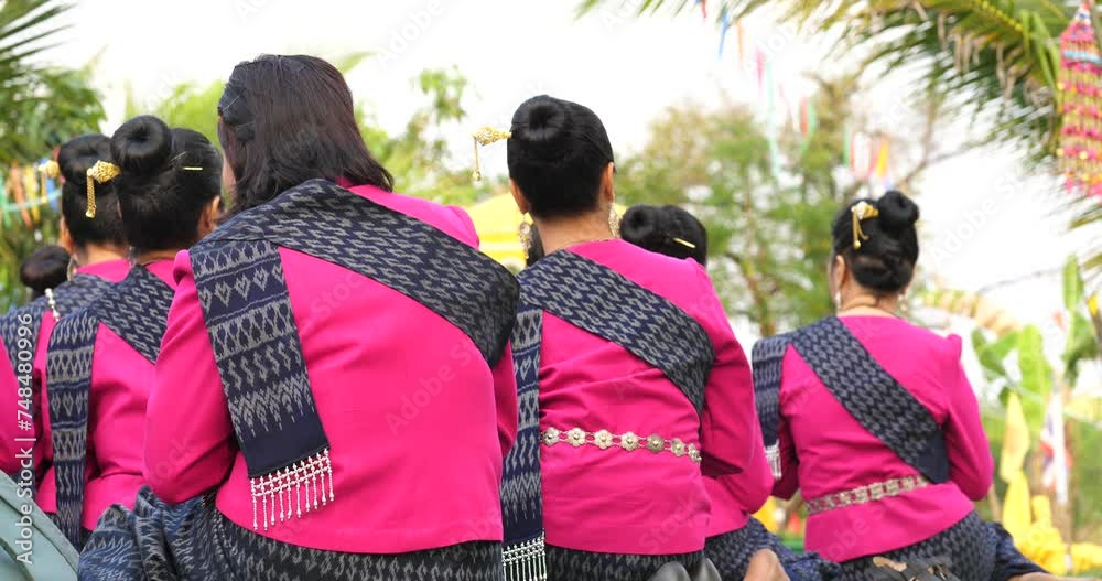 Behind the group of people were wearing traditional Thai clothing ...
