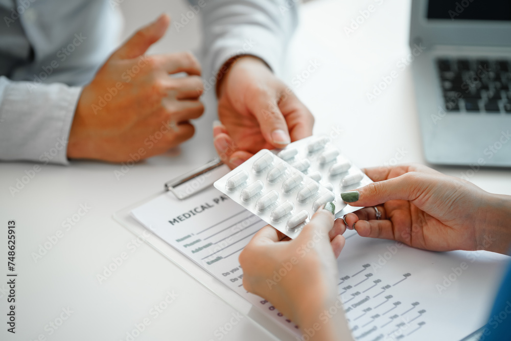 Female doctor provides crucial guidance to male patient in clinic room ...