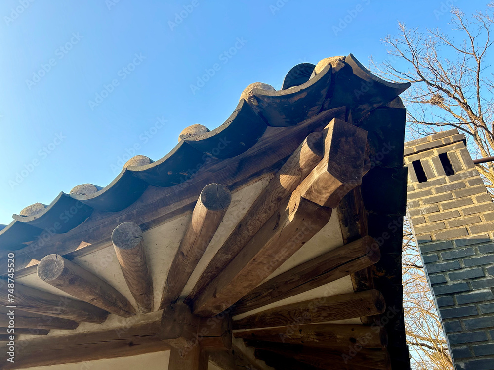Blue autumn sky and roof corners with roof tiles. It is an ...