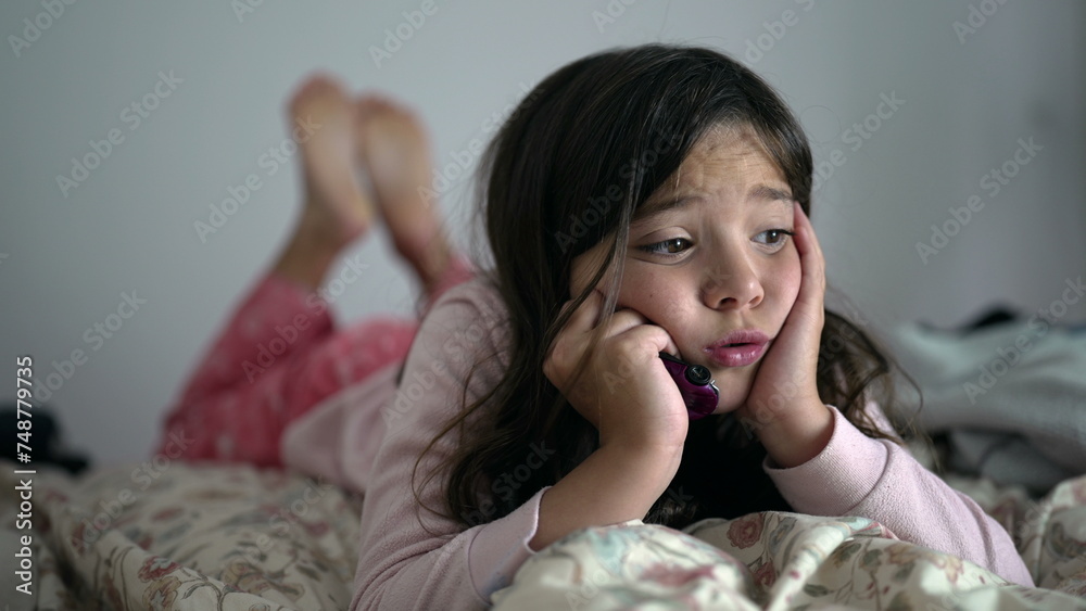 One bored little girl feeling extreme boredom with nothing to do laid ...