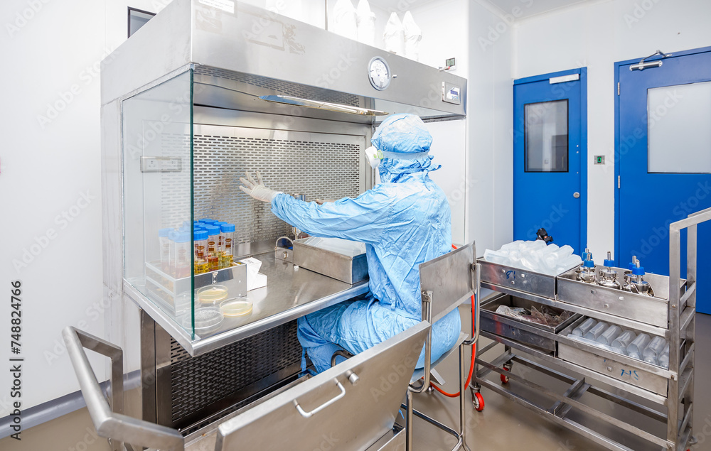 microbiologist in a laboratory working with petri dish in the ...