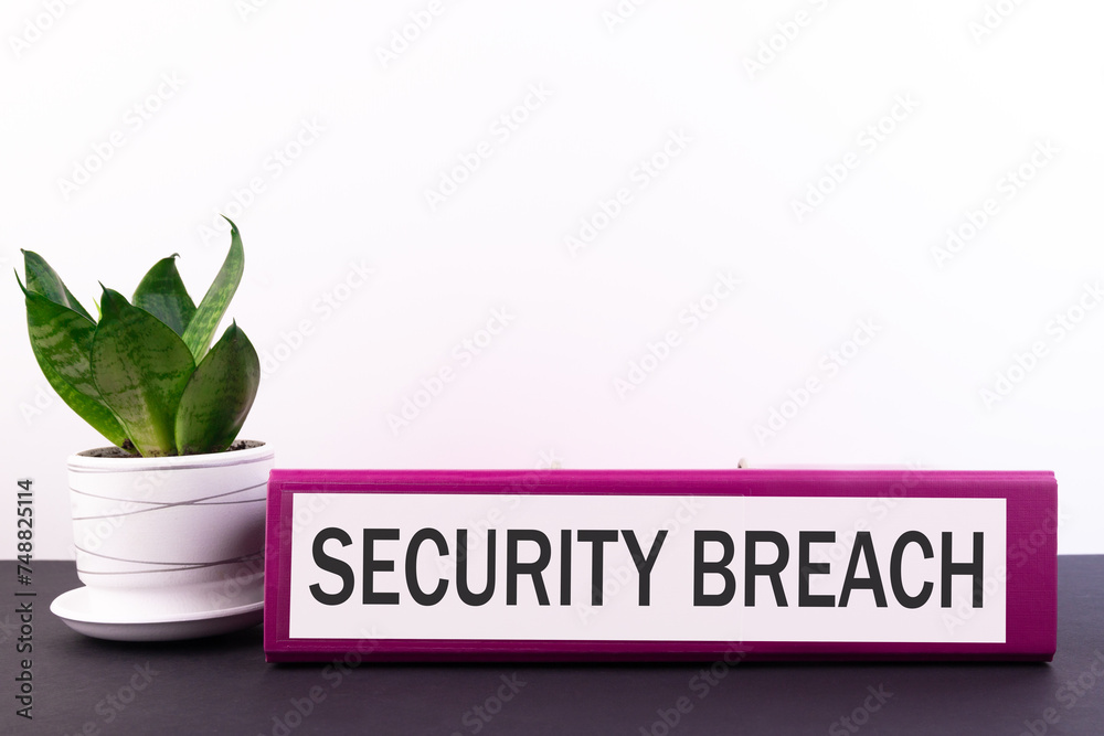 Folder with the text label Security Breach lies on a dark table with a ...
