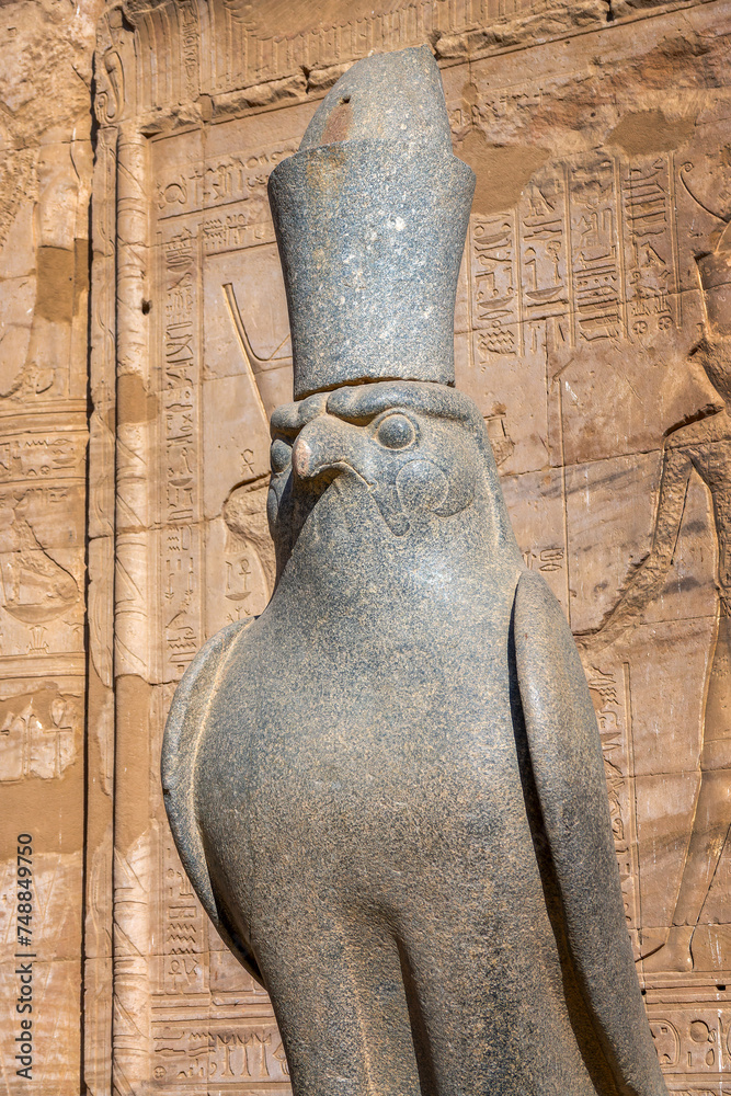 Ancient Falcon statue of egyptian god Horus in the temple of Edfu on ...