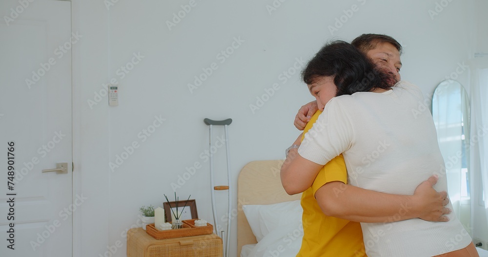 Embracing couple shares a heartfelt hug in a minimalist white room ...