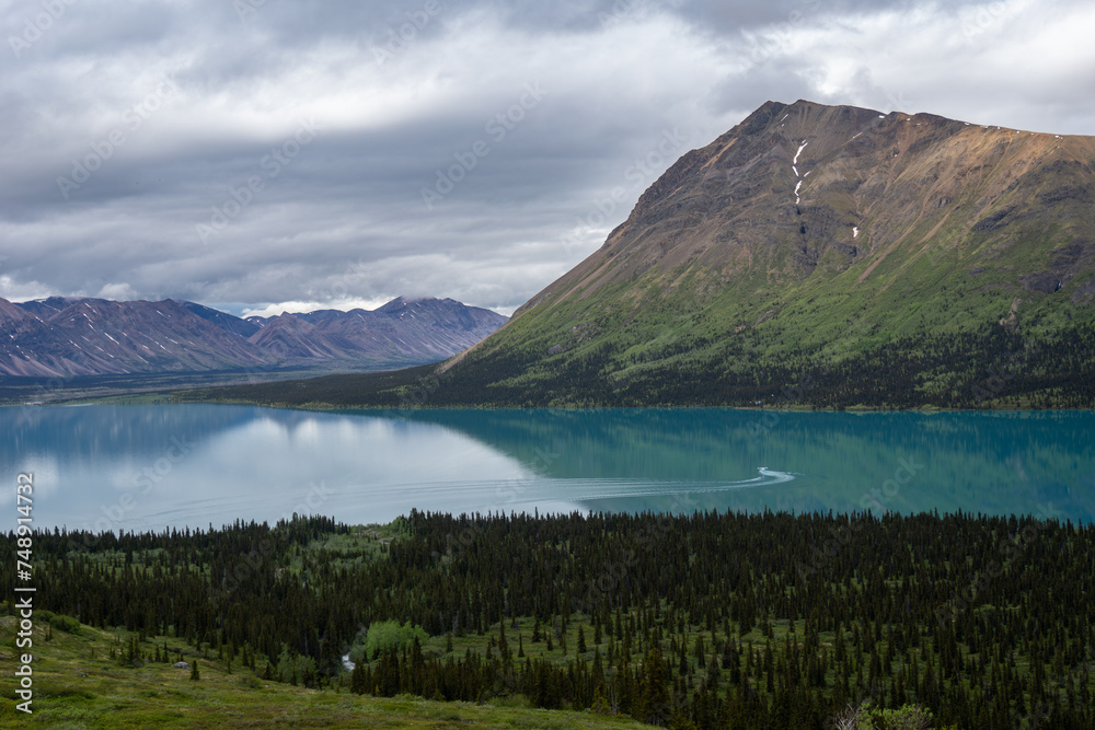 Seaplane lands at Upper Twin Lake for a Proenneke Cabin tour. The cabin ...