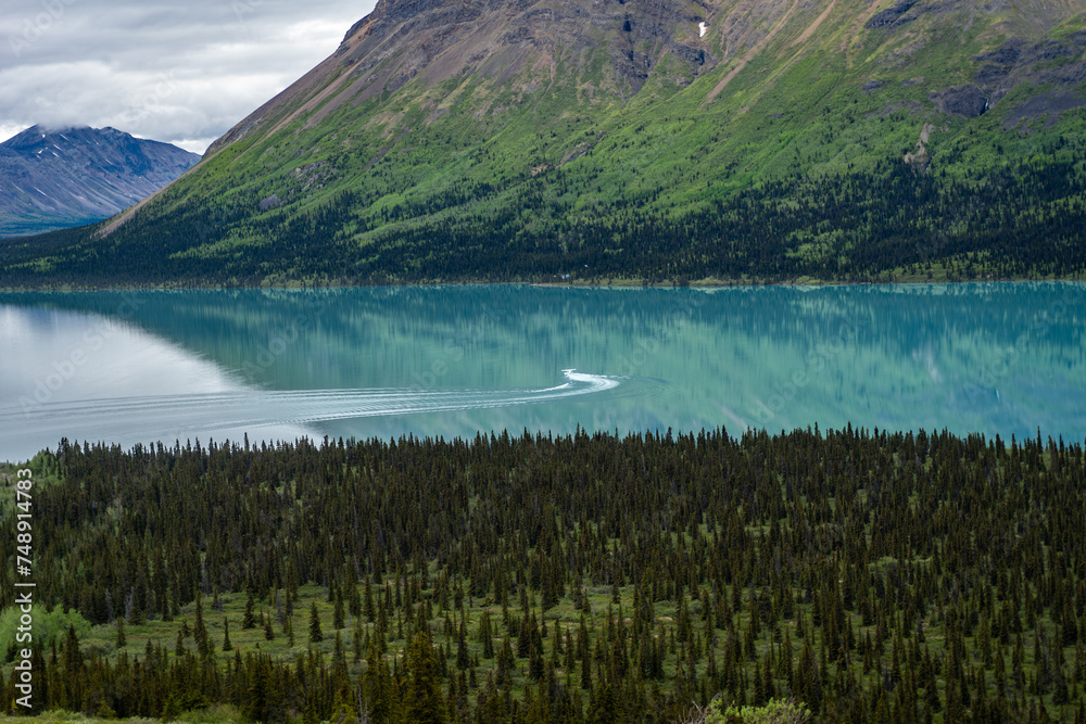 Seaplane lands at Upper Twin Lake for a Proenneke Cabin tour. The cabin ...