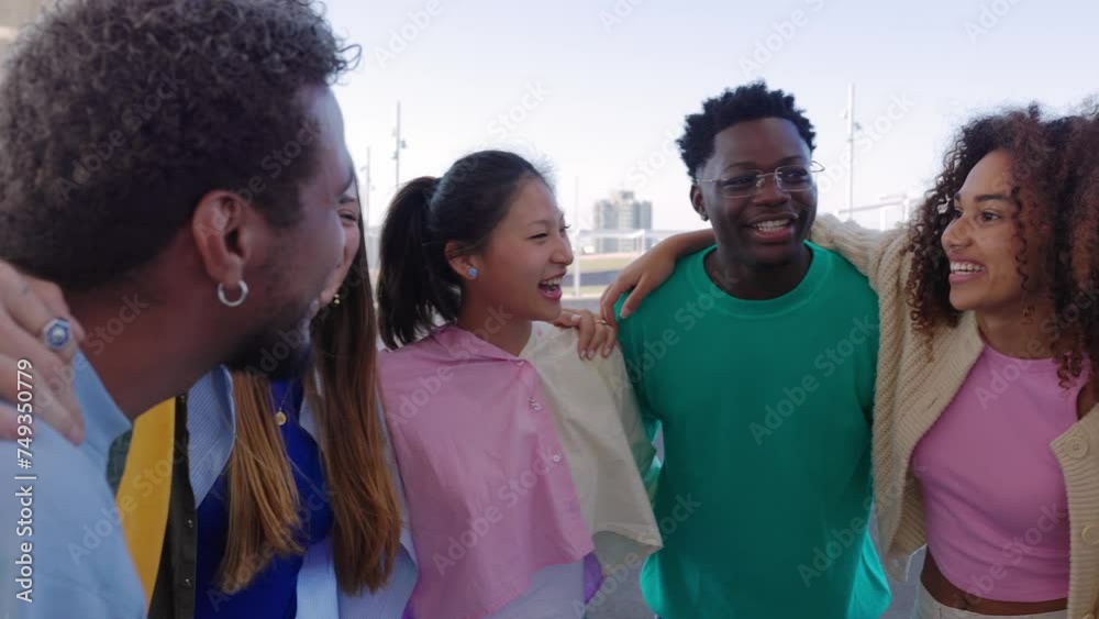 Young group of teenage friends laughing together bonding outdoors. Gen ...