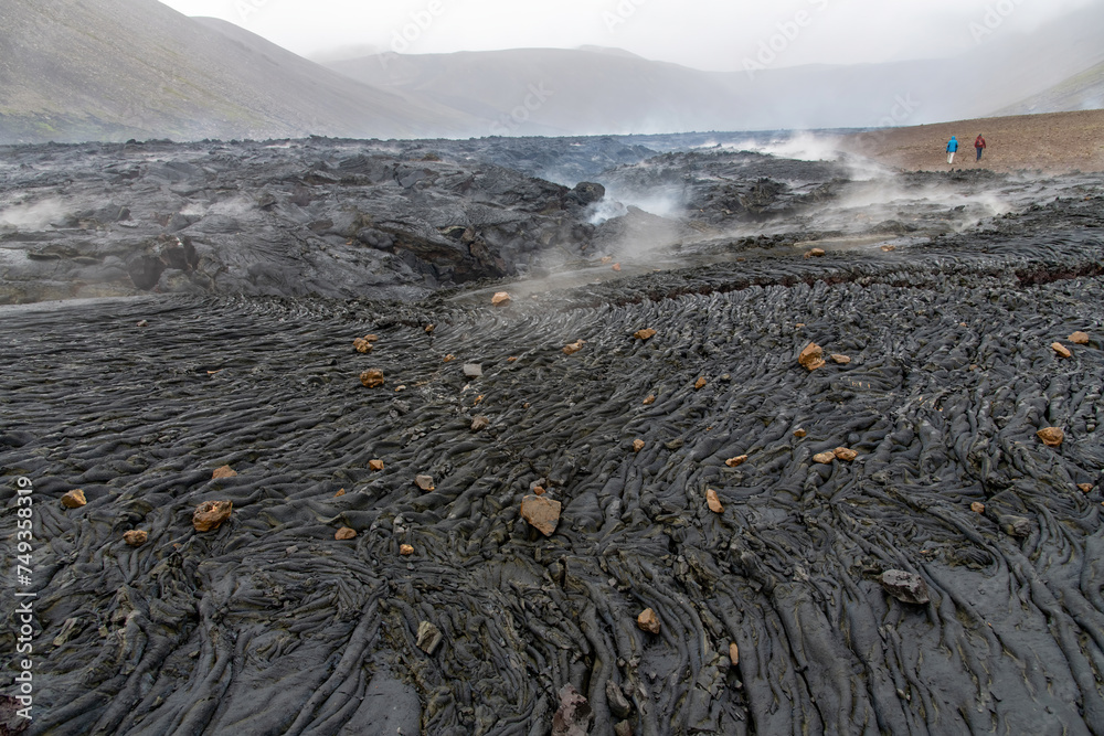 View of cracked lava crust or ingenious rock and steam, cooled down ...