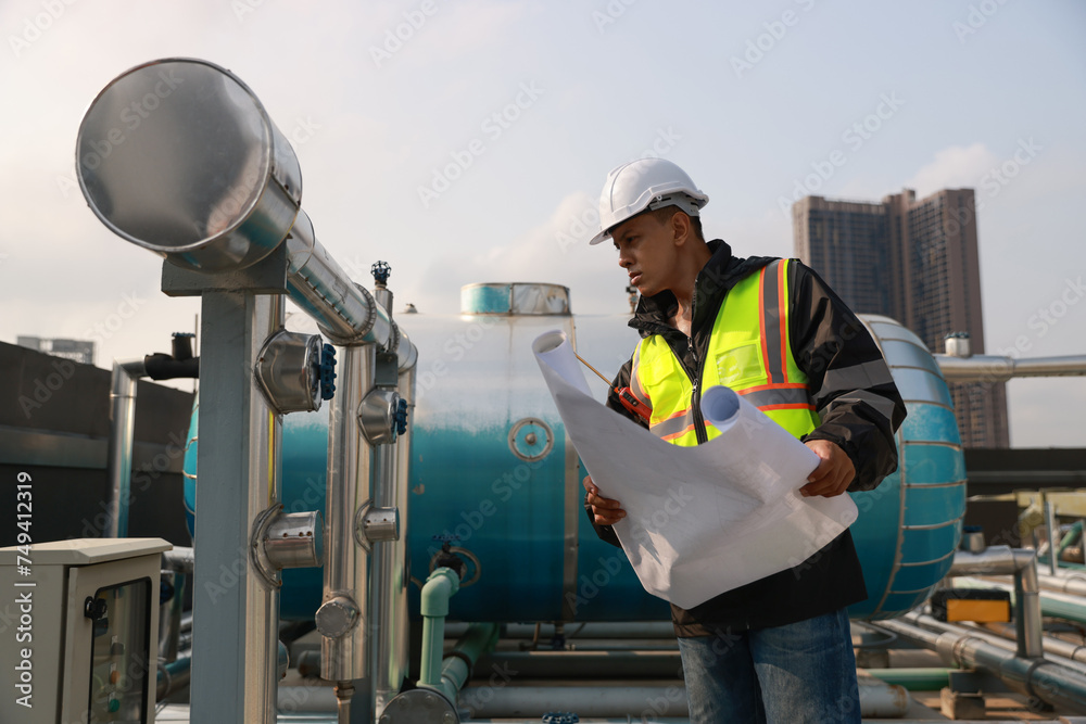 Foreperson with HVAC system checking the equipment installation with ...