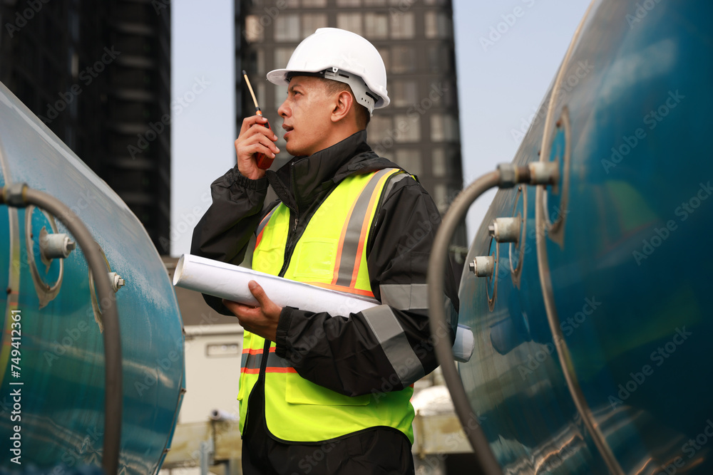 Foreperson with HVAC system checking the equipment installation with ...