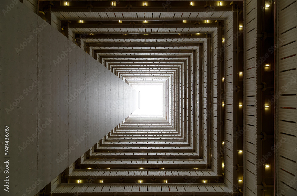 Low angle diminishing perspective view from the atrium of a multistorey ...