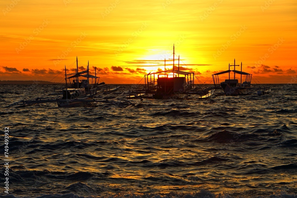 Evening sun and waves on the ocean, anchoring boats. Ship on the ...