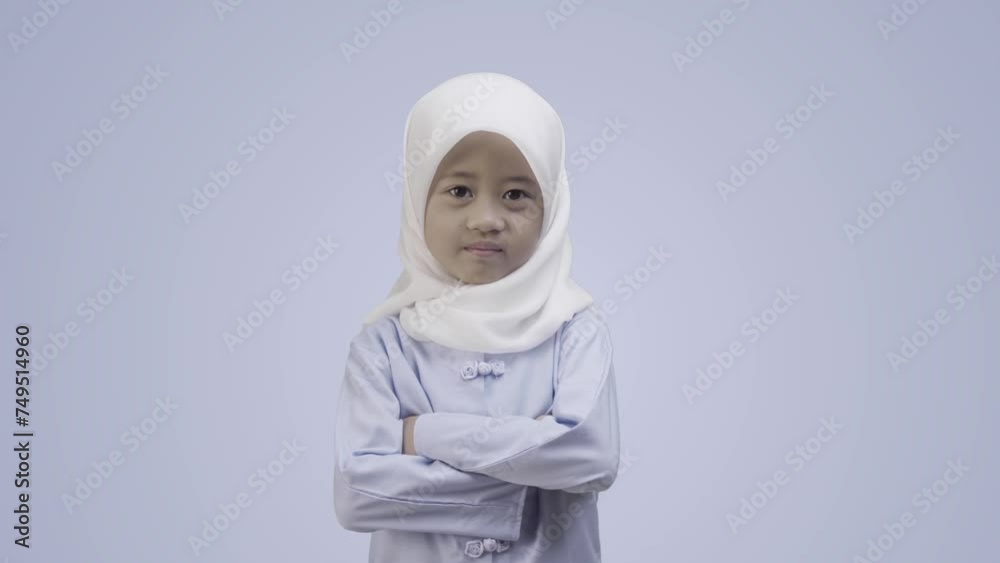 Muslim little girl with hijab cross arms on a isolate grey background ...