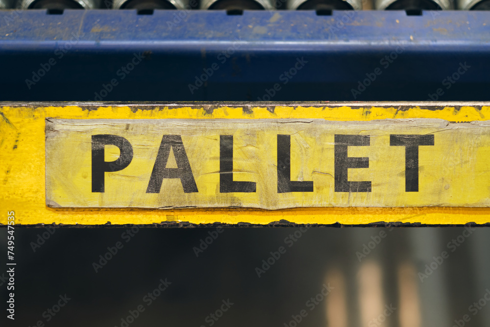 A yellow vibrant eye catching pallet loading bay sign. Storing stacks ...