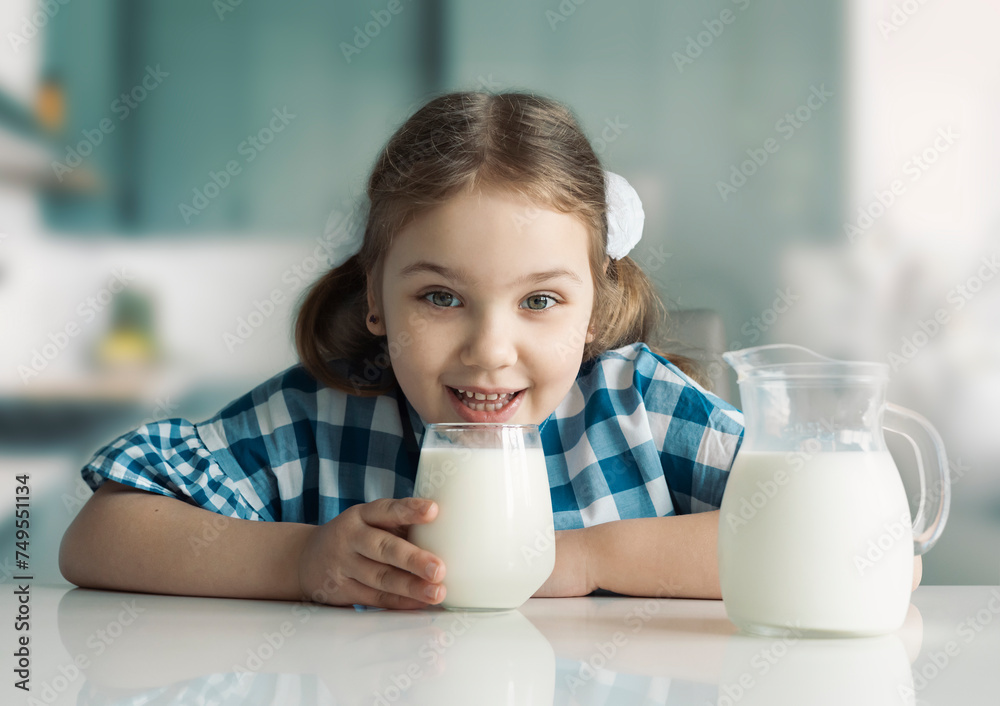 Caucasian child drinks milk. Little girl with a glass of milk at ...