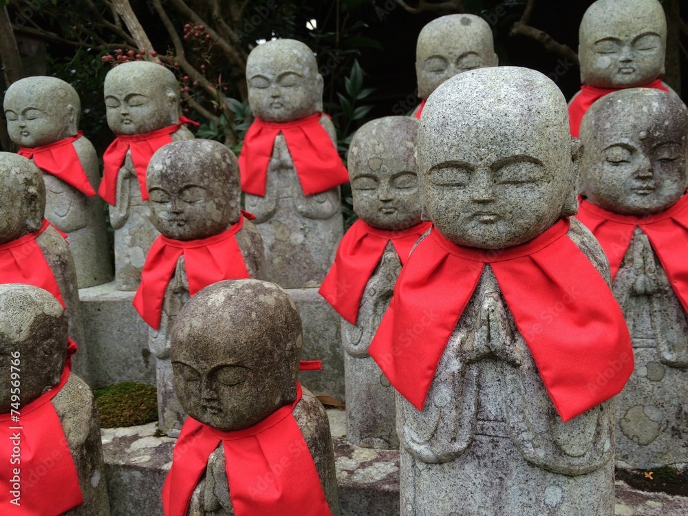 Jizo, a stone statue with a red bib, symbolizes compassion and ...