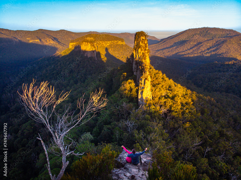 aerial view of couple admiring the panorama of mountains in main range ...