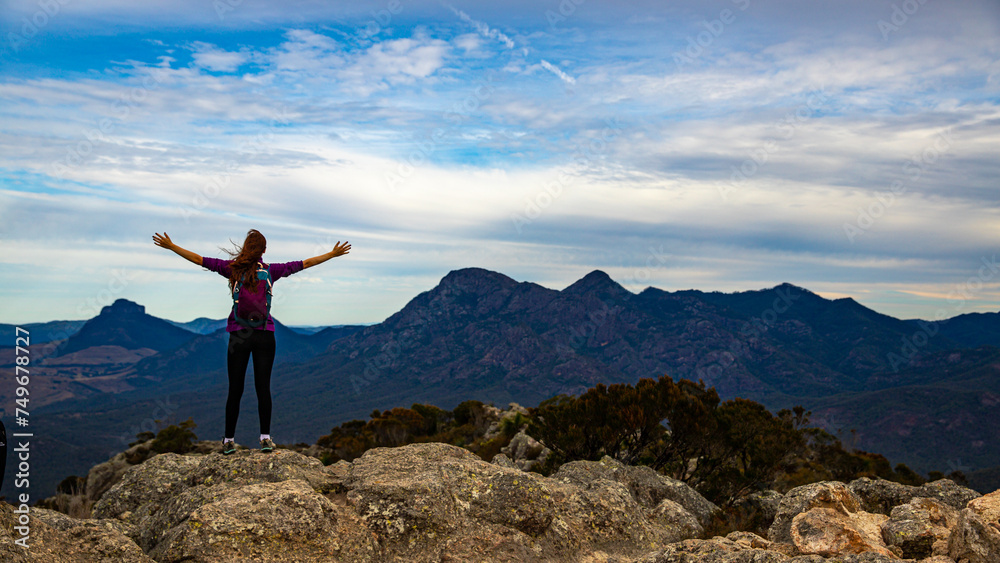 backpacker girl celebrating successful hike to the summit of mount ...