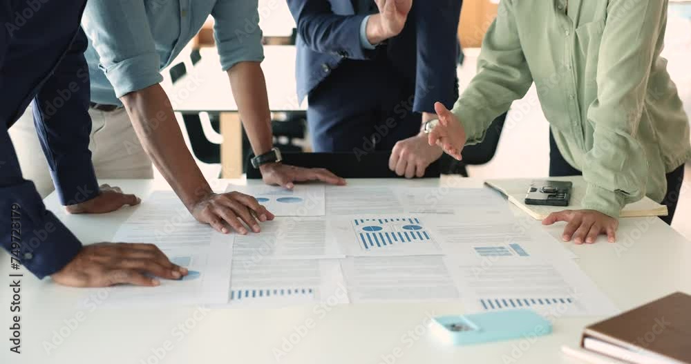 Businesspeople analyzing report shown in charts, graphs and diagrams ...