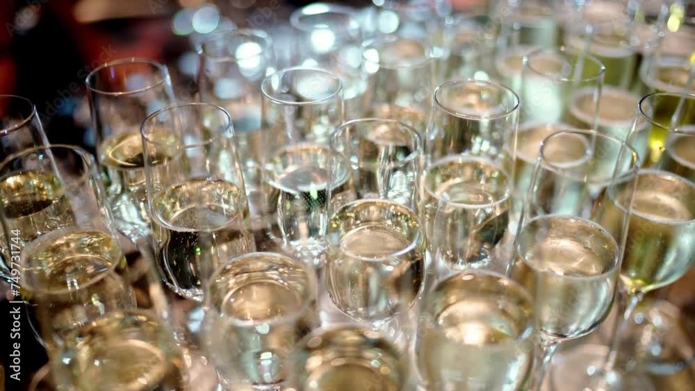 A collection of champagne glasses are neatly stacked on a table, ready ...