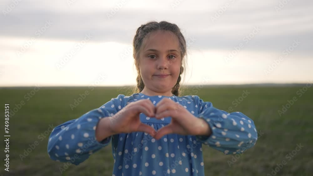 Happy cute girl with kind heart. child makes heart with his hand. Cute ...