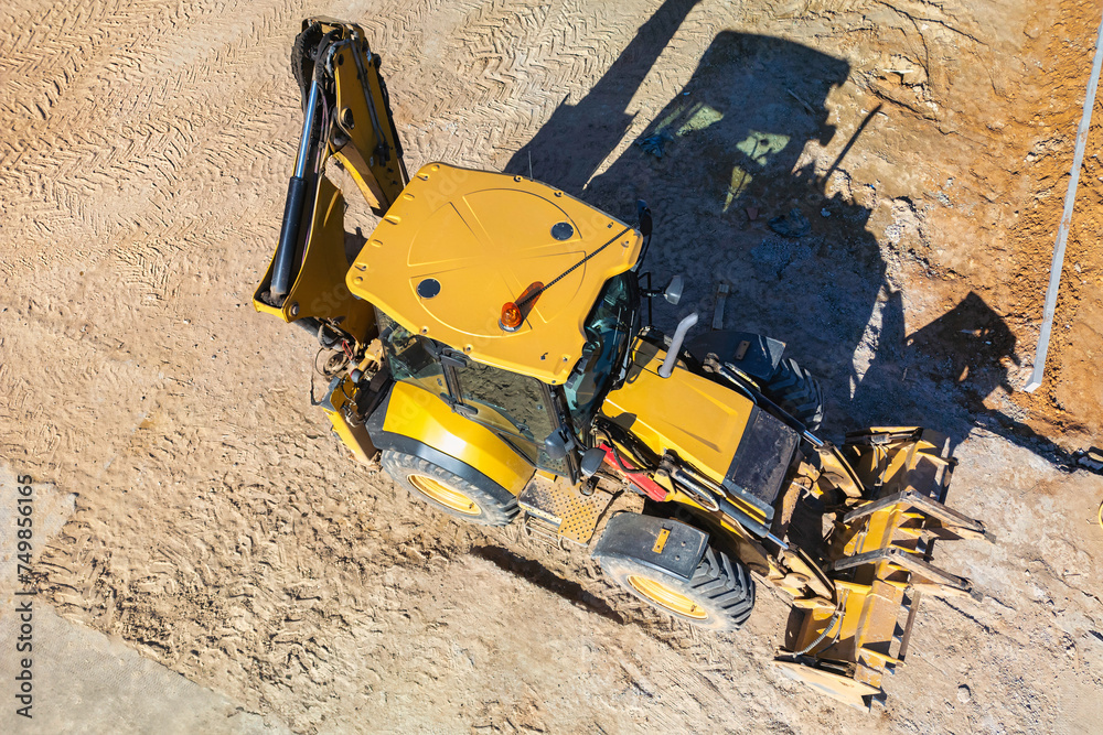 Universal excavator or loader with folded bucket at construction site ...