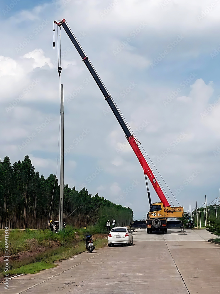 115kV utility pole installation, The crane truck is lifting of electric ...