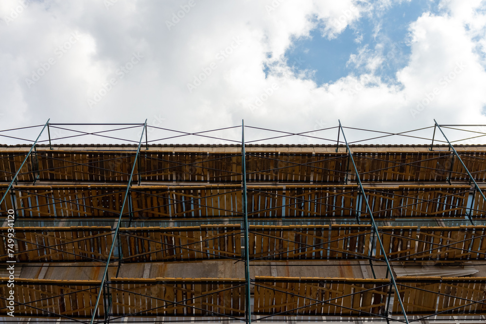 Low angle view of extensive wooden scaffolding on building during ...